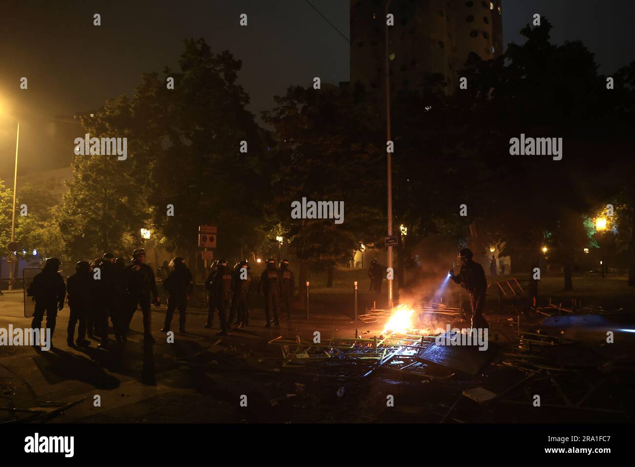 Riot police officers patrol on the third night of protests sparked by ...