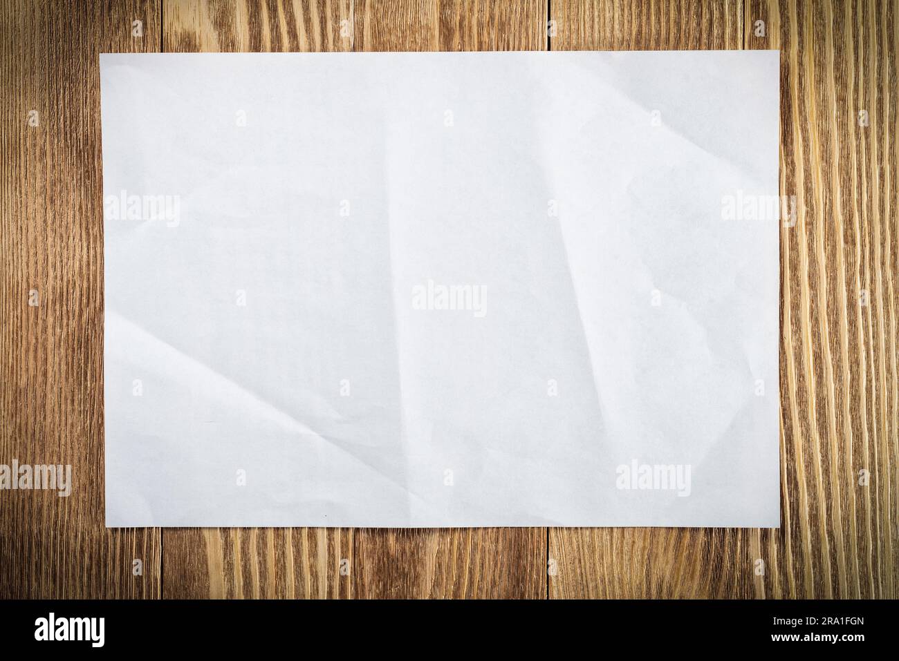 Flat lay wooden table with paper sheet Stock Photo - Alamy