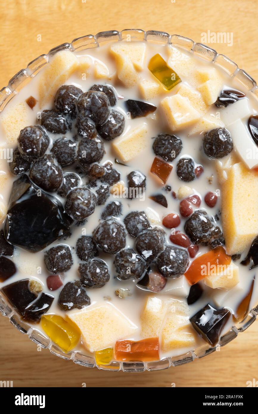 top view bowl of grass jelly on a wood background at vertical ...