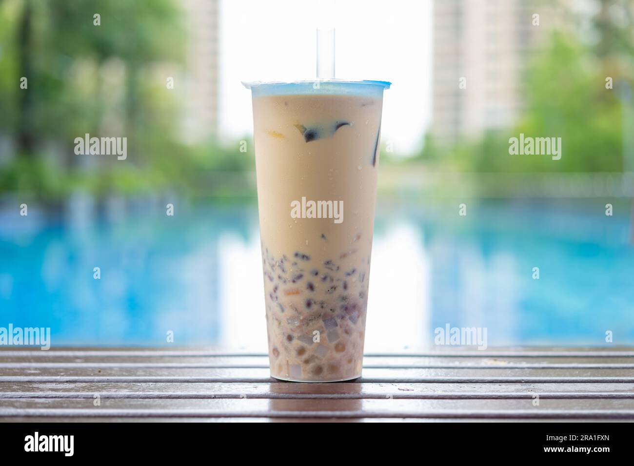 cup of grass jelly near a swimming pool at horizontal composition Stock ...