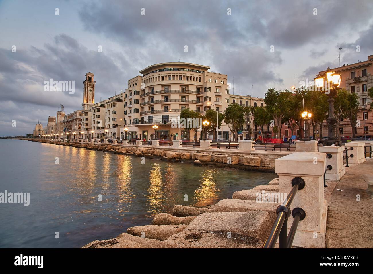 Empty benches and lamp posts at seafront and promenade in Bari, Italy ...