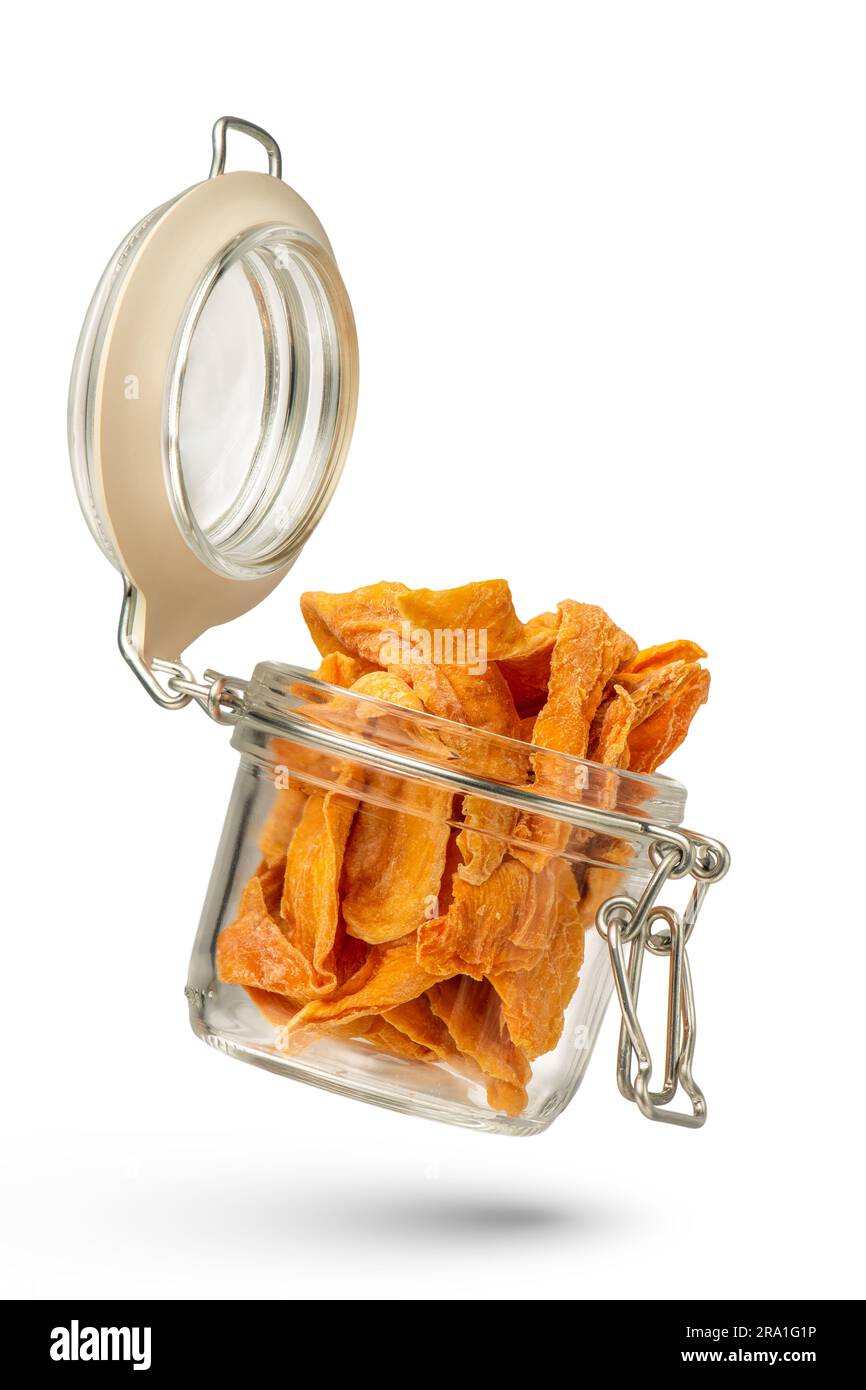 Storage of dried fruits. Dried mango slices are stored in an open glass ...