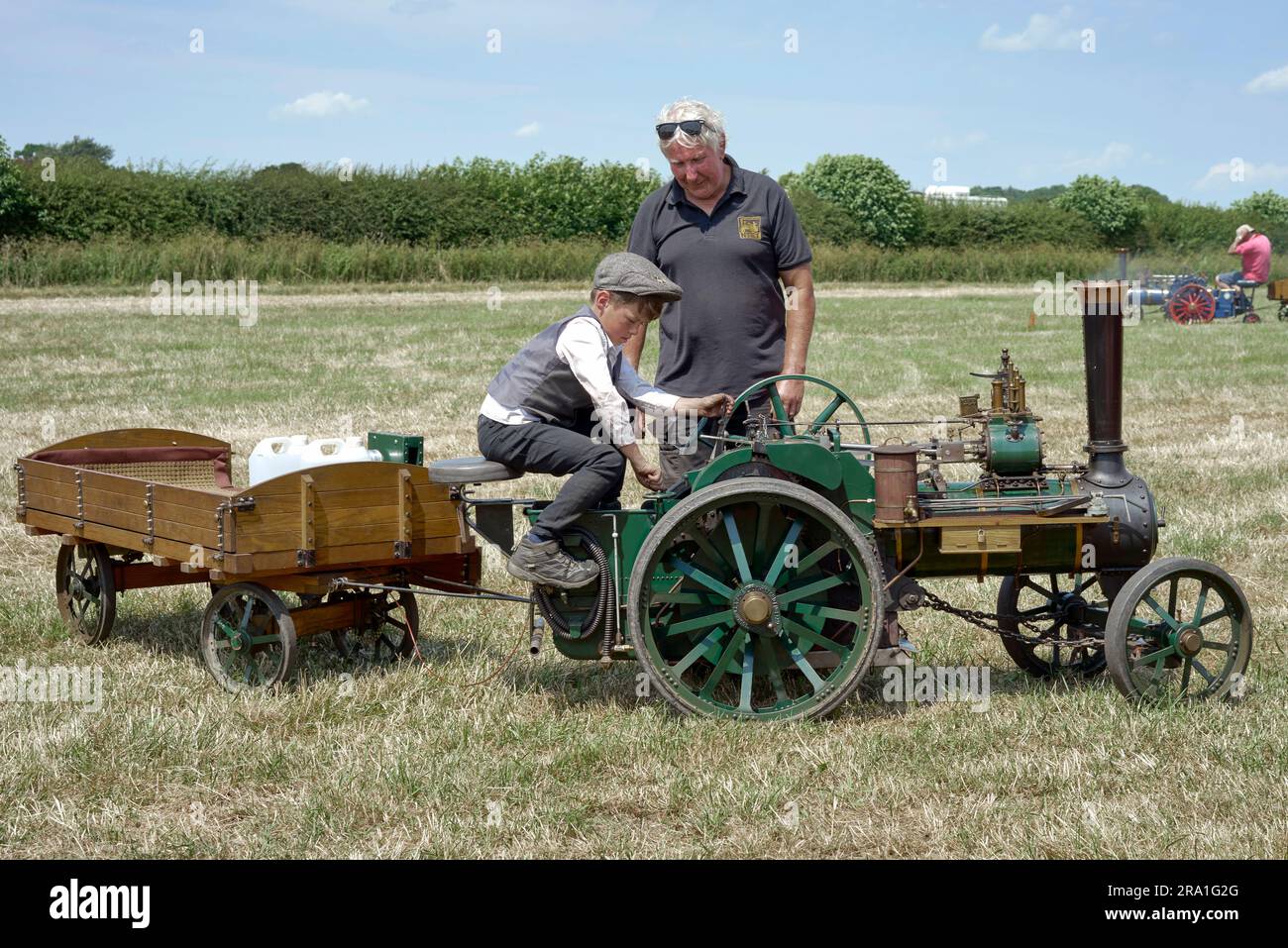 Steam Traction Engine, miniature scale model with child driving at an ...