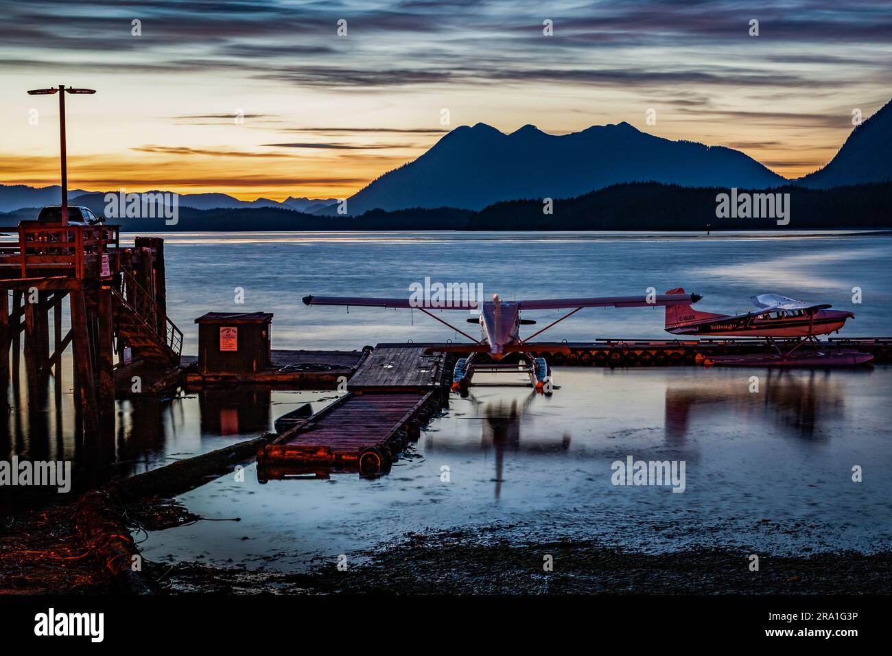 A hydrofoil parked at the pier, while a sunset envelops the landscape ...