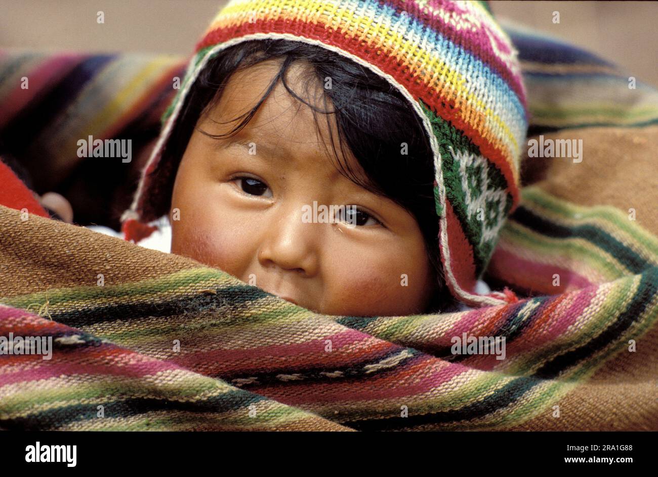 Peru, Portrait of a small child wearing a traditional knitted cap ...