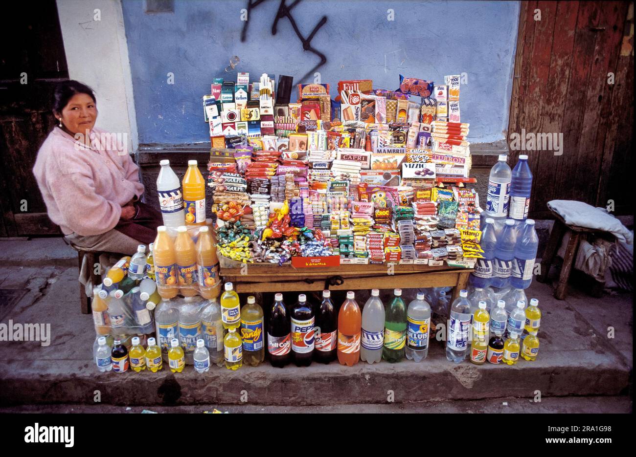 Peru, Lima, woman sells beverages, sweets and cigarettes in the street ...