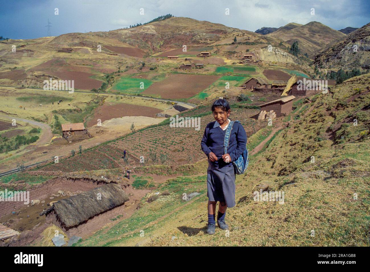 Peru, girl wearing uniform on her way to school from her rural village ...
