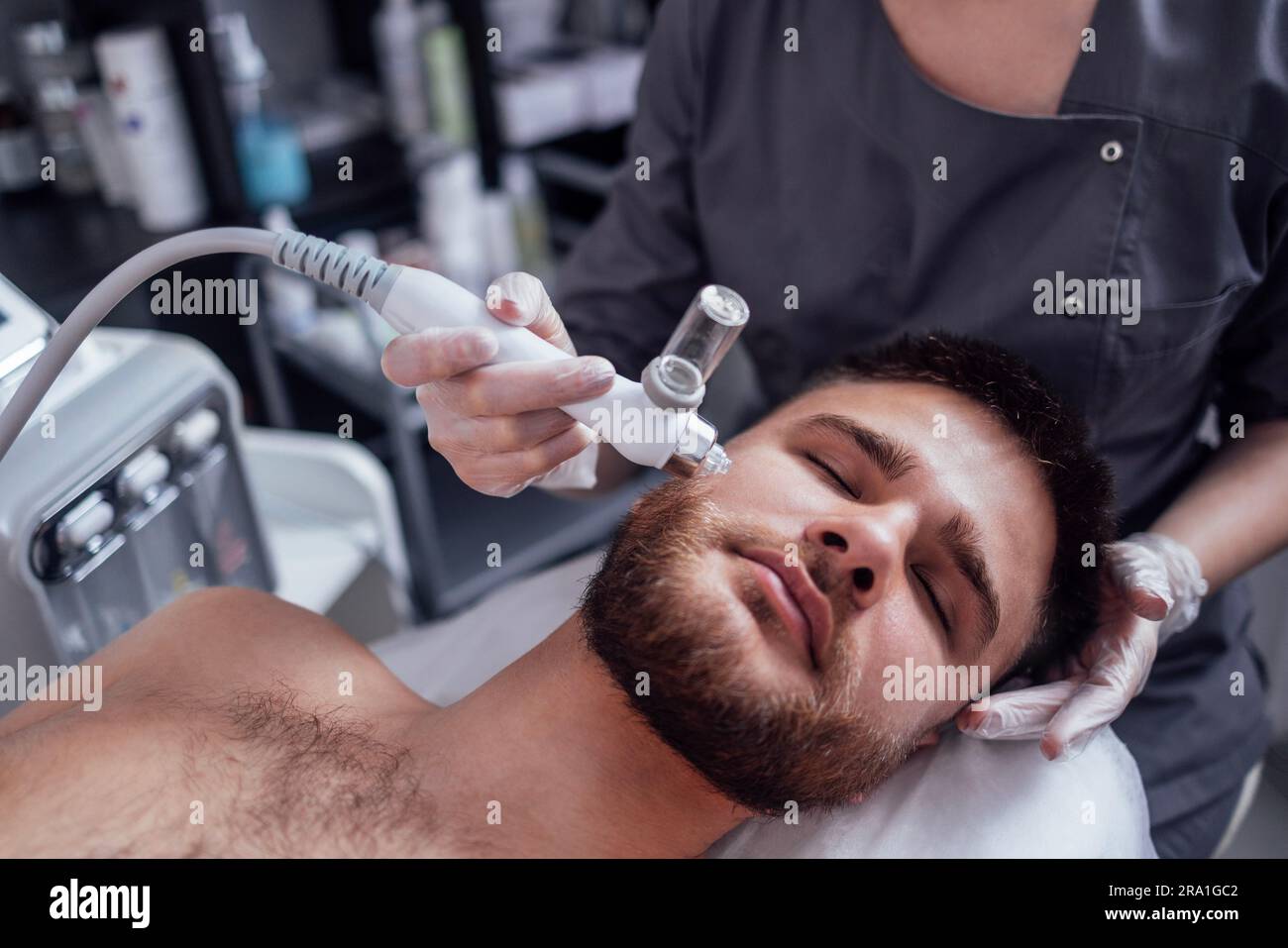 Caucasian man getting face peeling procedure in a beauty clinic, close ...