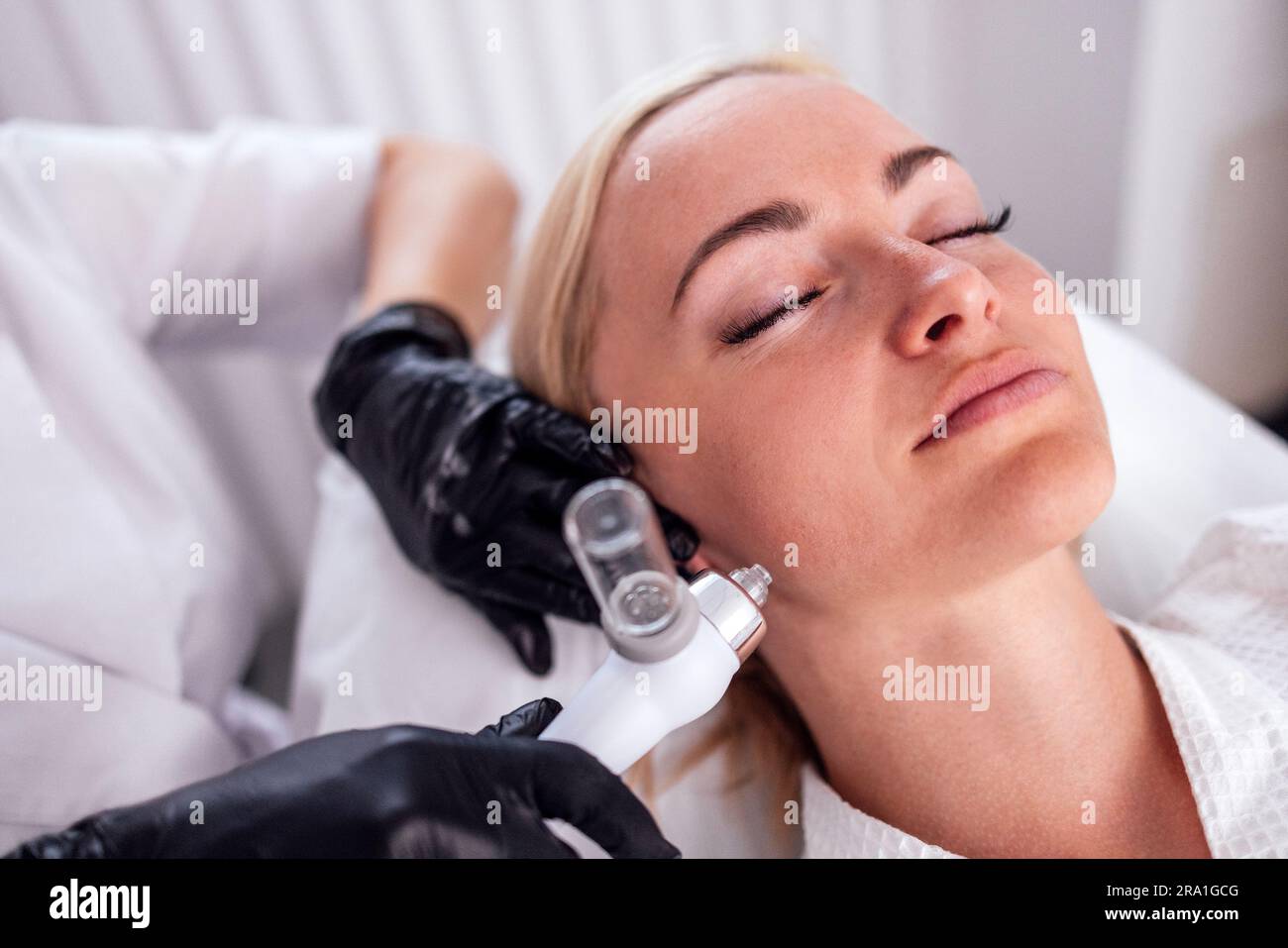 Caucasian woman getting face peeling procedure in a beauty clinic ...