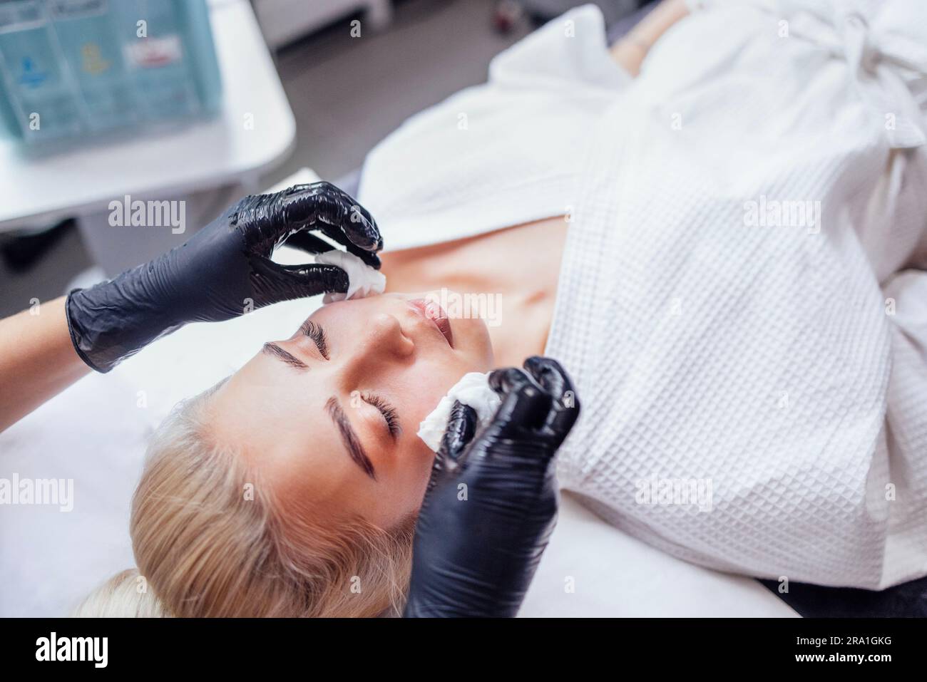 Close up of face of young blonde girl lying with her eyes closed during ...