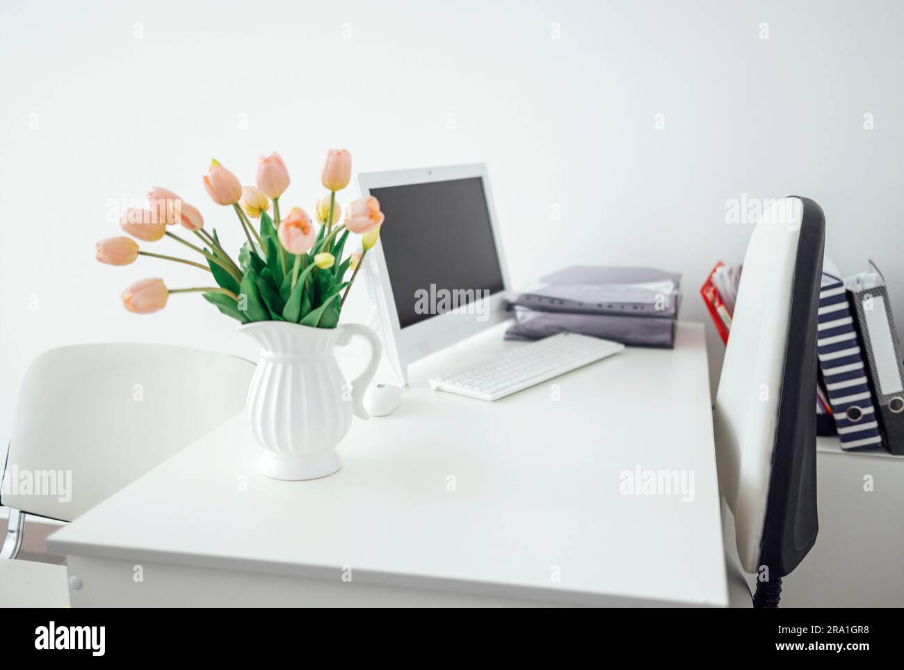 a workplace with a computer, a keyboard, folders with documents and a ...