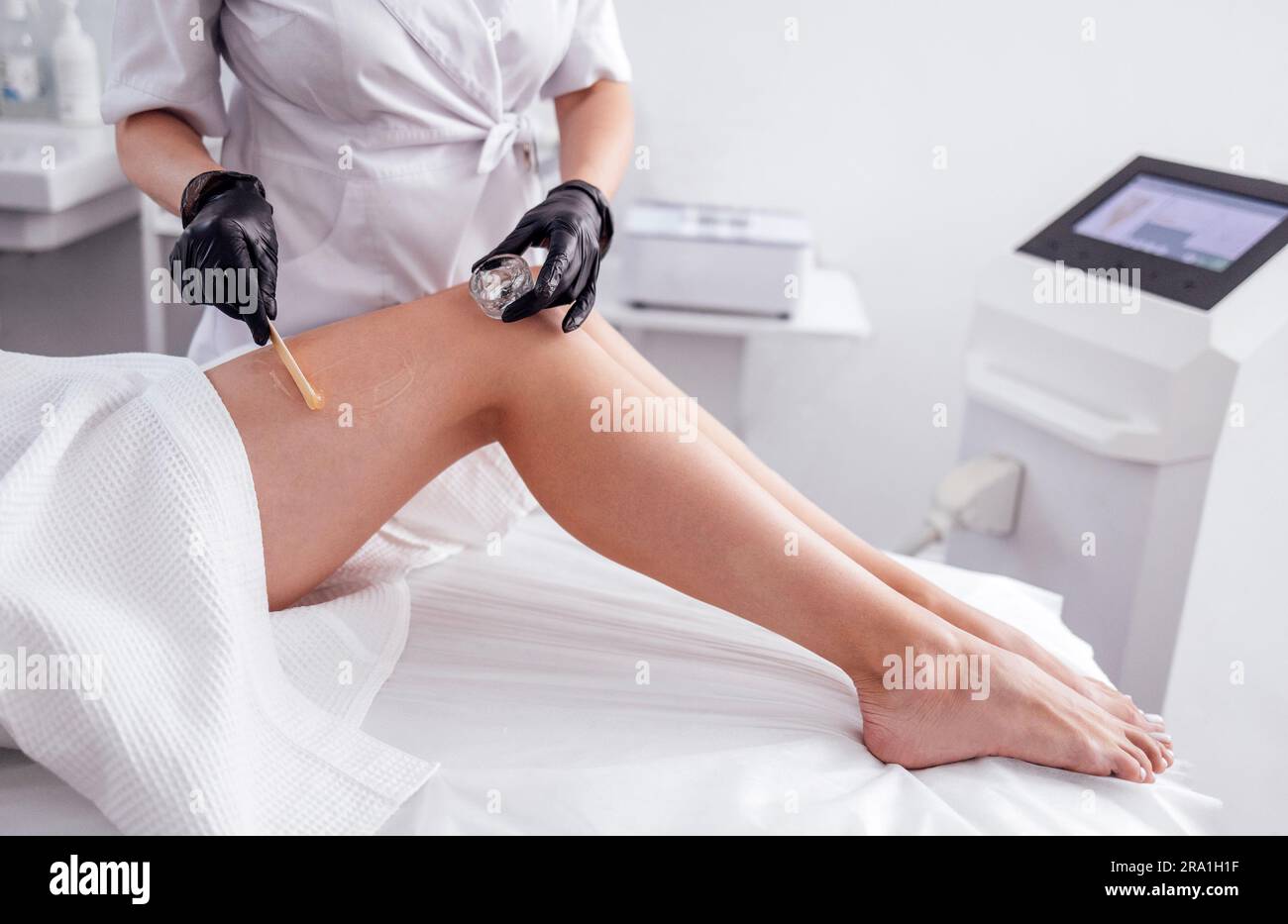 Preparation of clients legs before laser hair removal procedure in spa ...