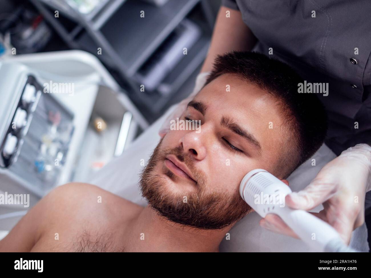 Closeup of face of beautiful relaxing man undergoing hardware ...