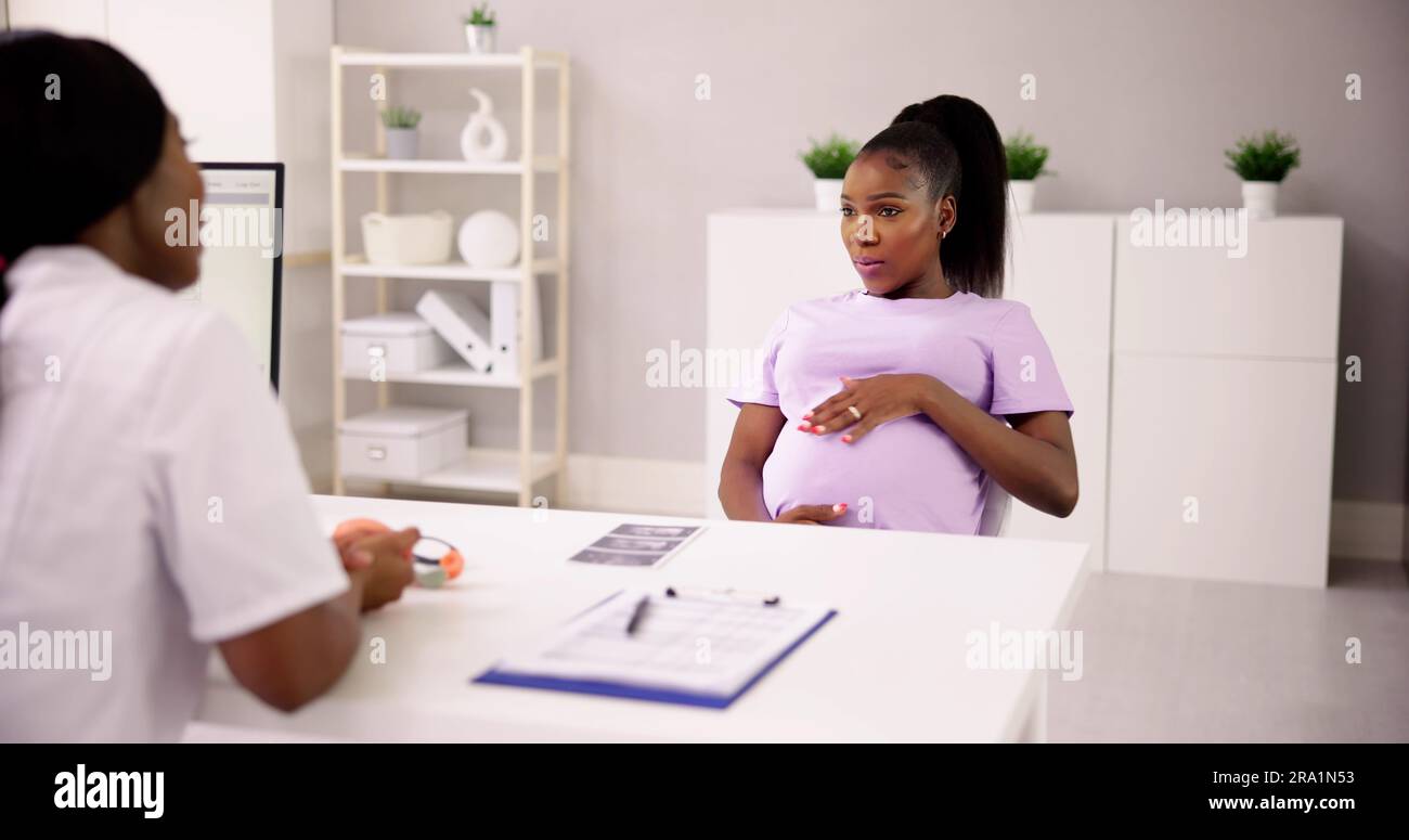 Female Doctor Explaining Ultrasound Scan To Woman In Hospital Stock ...