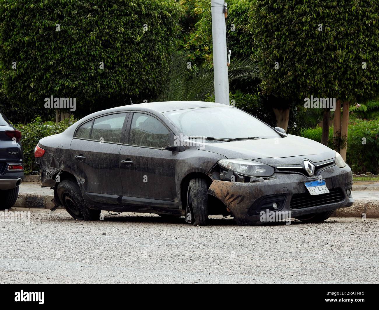 Cairo, Egypt, June 6 2023: Black wrecked car damaged by accident on the ...