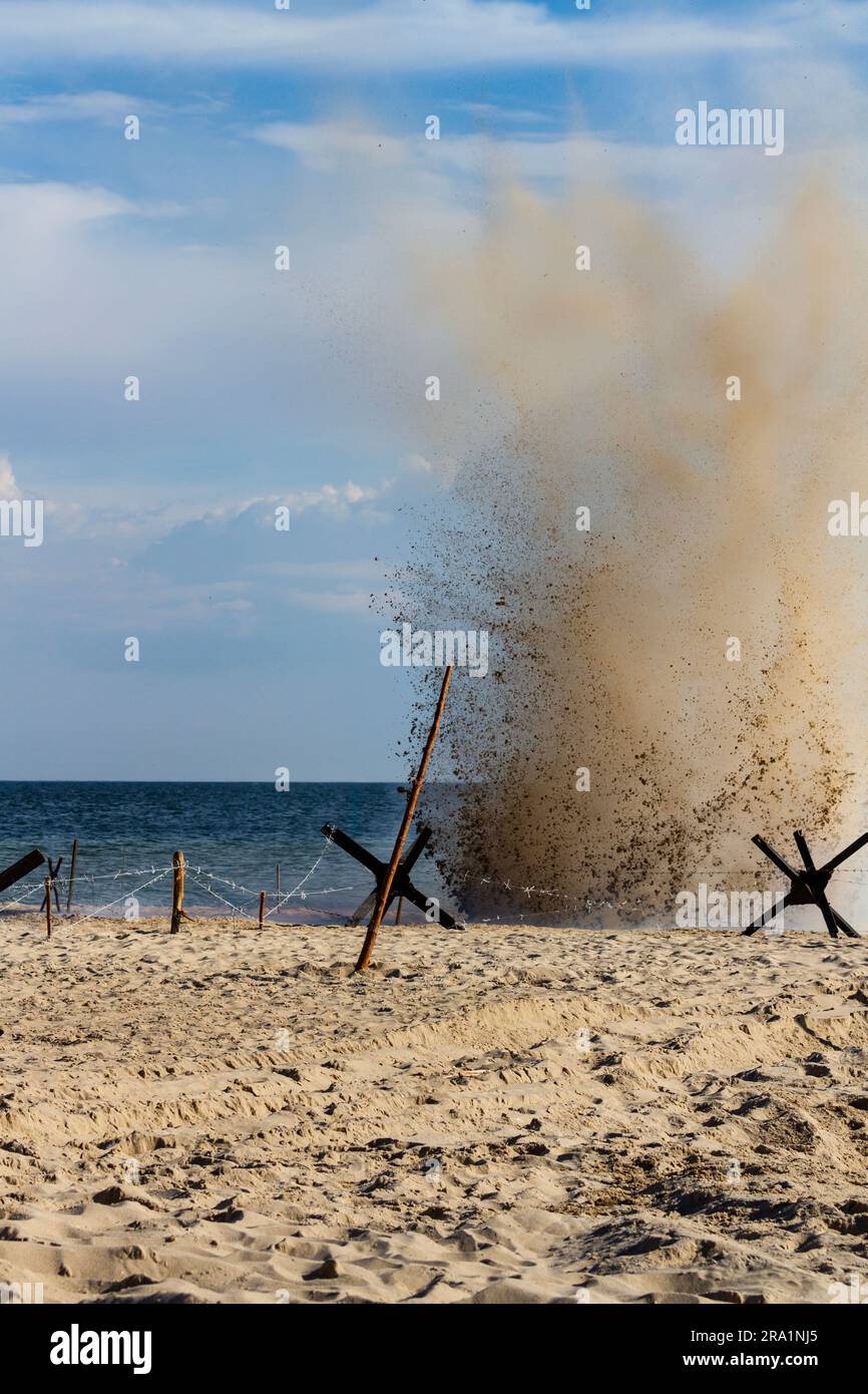 Background. Bombs exploding on the beach. Reconstruction of battle from ...