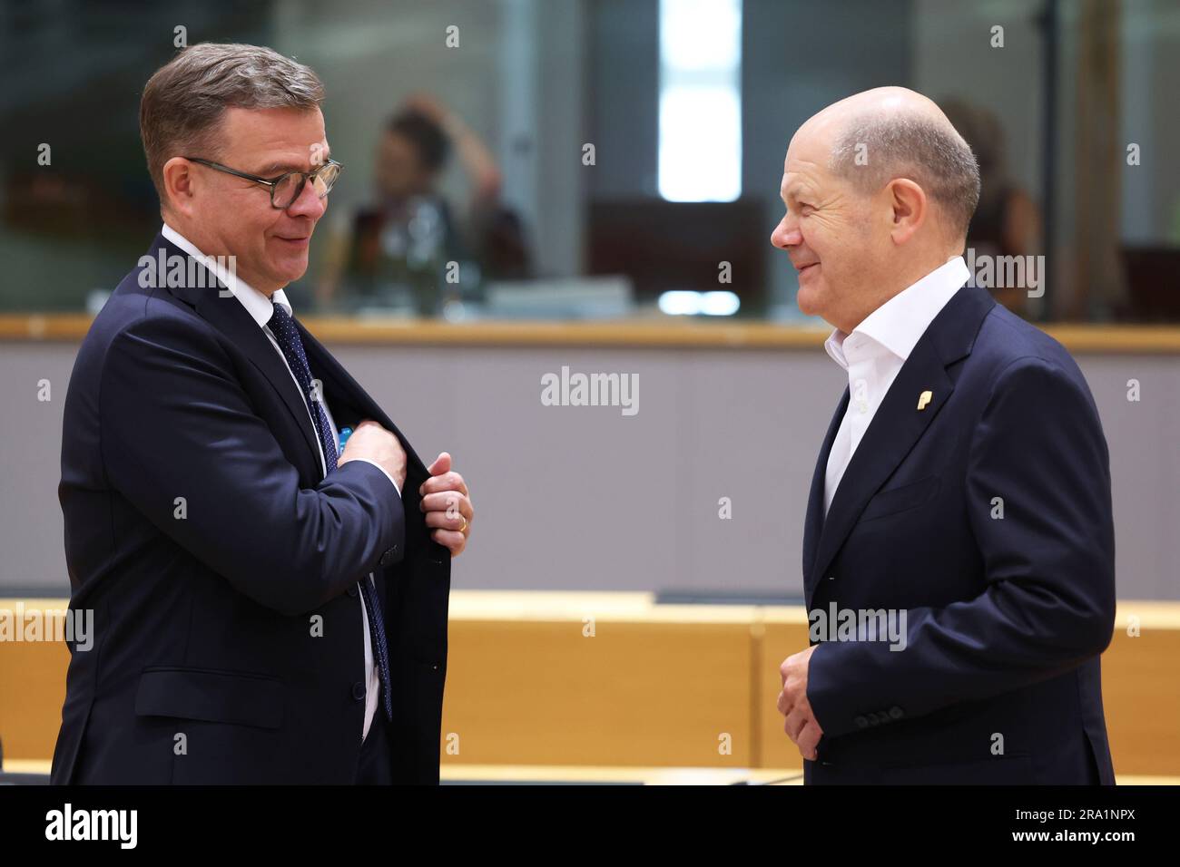 Germany's Chancellor Olaf Scholz, right, speaks with Finland's Prime Minister Petteri Orpo ...