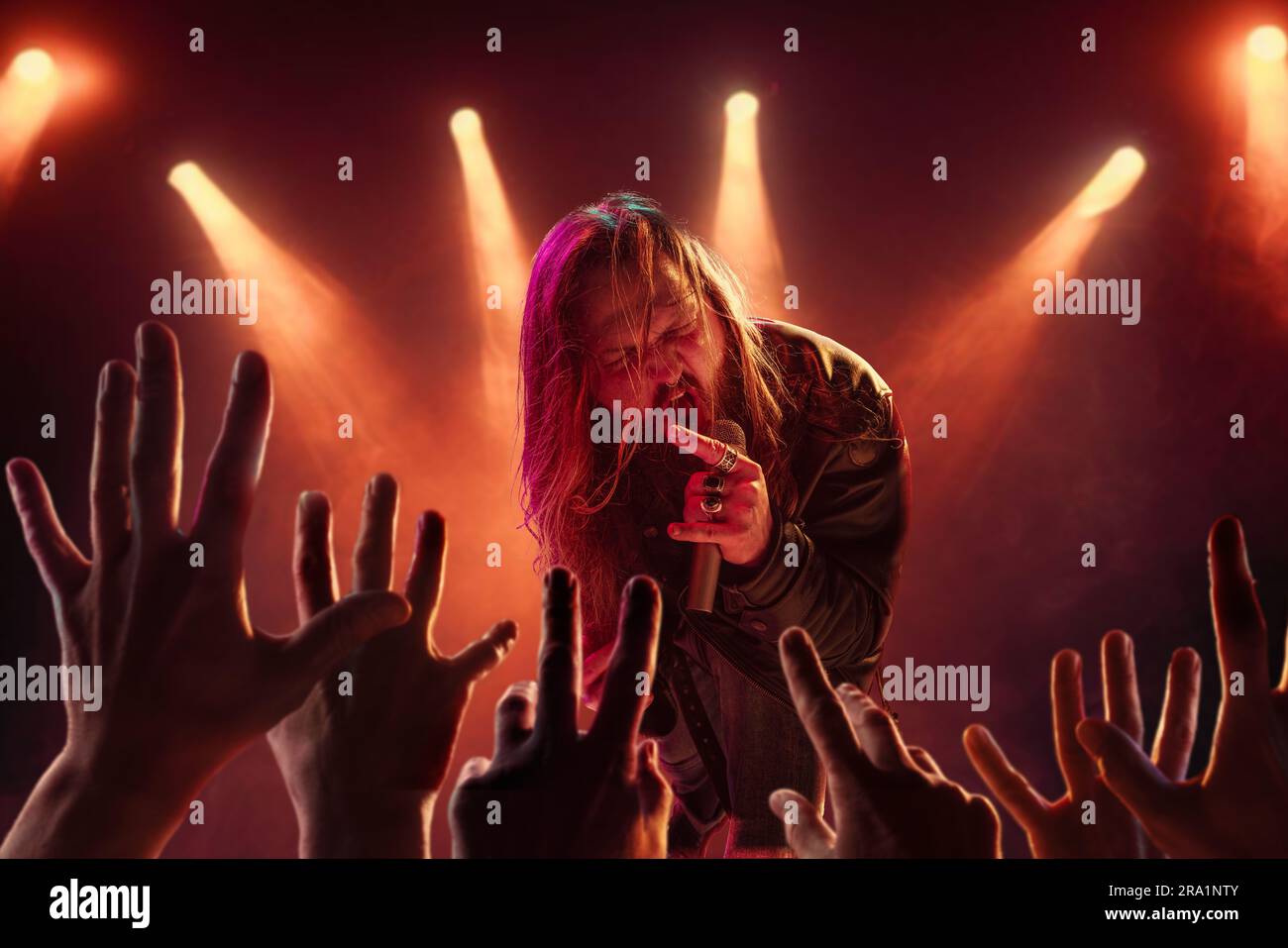 Expressive, talented man, musician making own concert, singing on stage ...