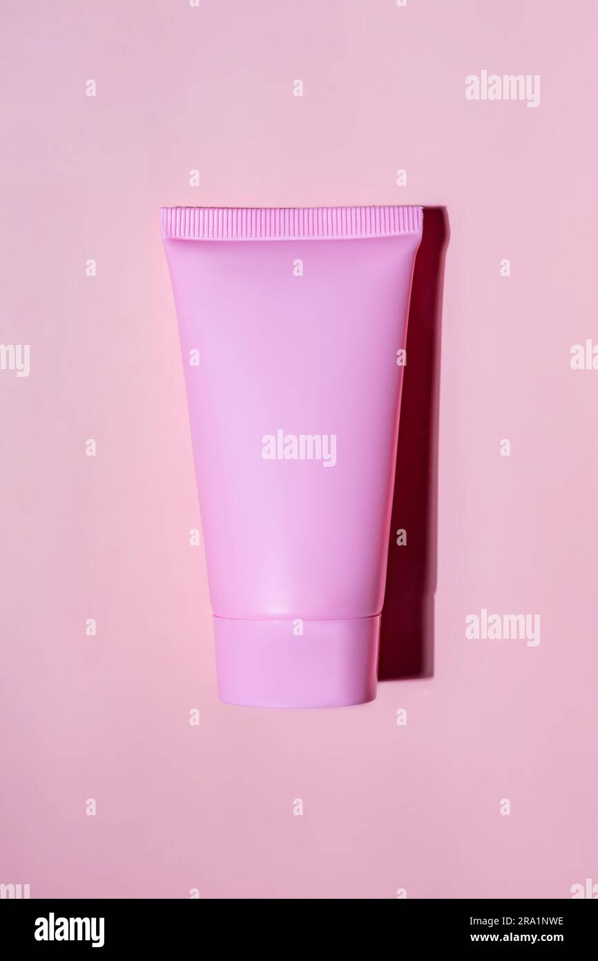 mockup of pink squeeze bottle plastic tube for branding of medicine or ...