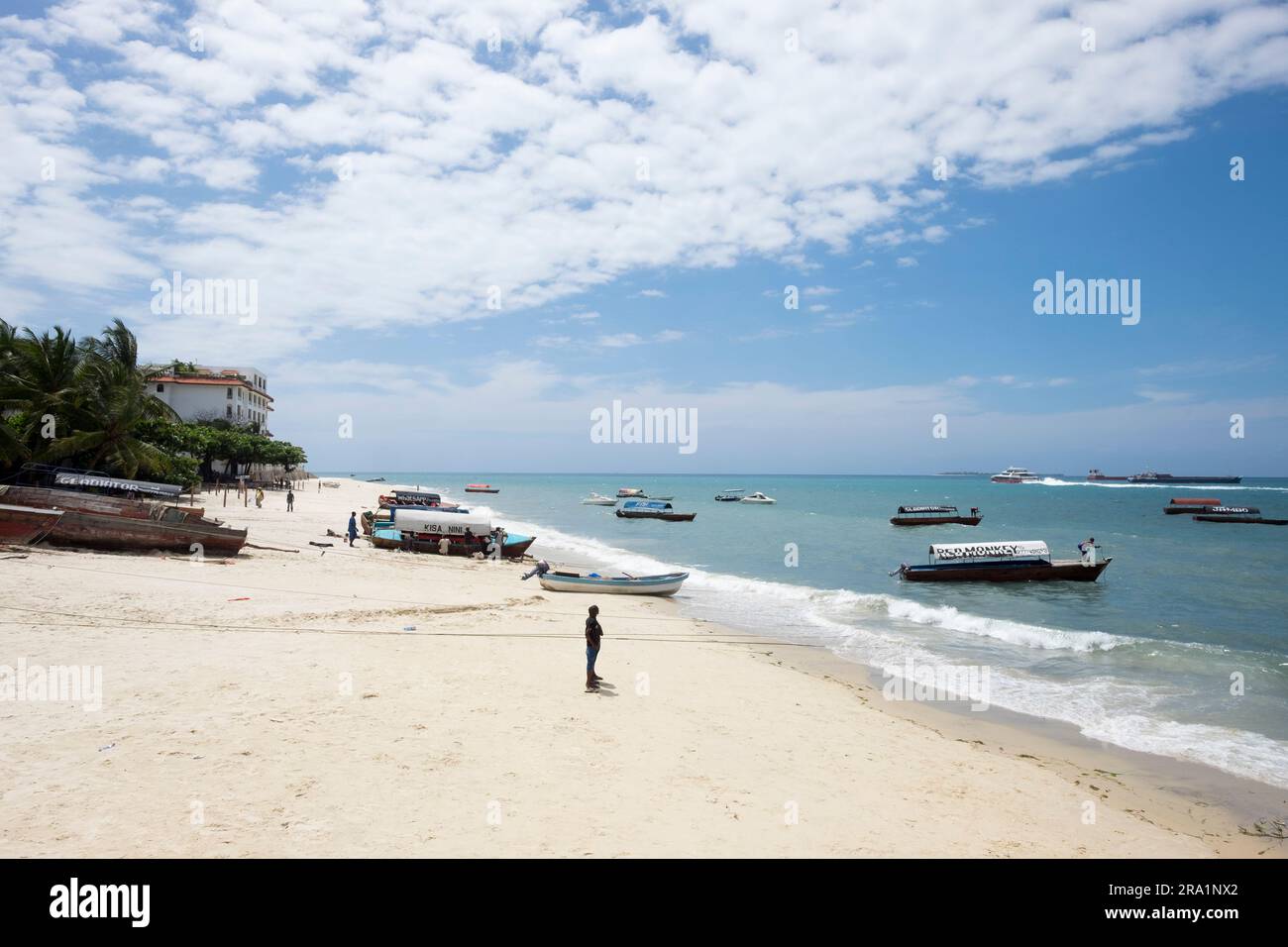 A closeup of a scenic Beach of Zanzibar with clear blue waters and ...