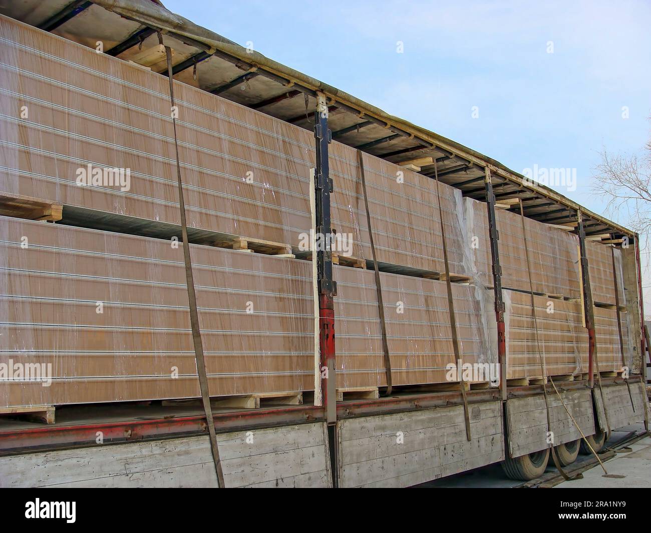Cargo trailer carrying insulated sandwich panels for warehouse ...