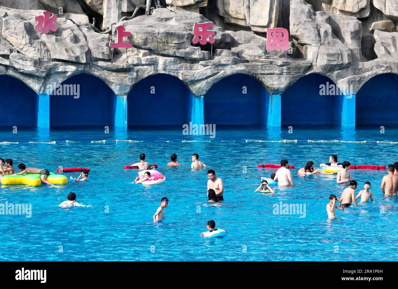 Aerial photo shows people playing at a water park to enjoy coolness in ...