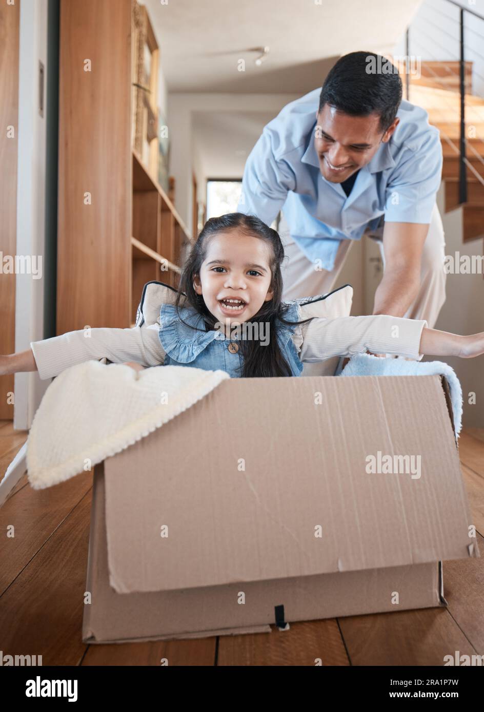 Dad, child and box, playing on floor in home with love and fantasy for ...
