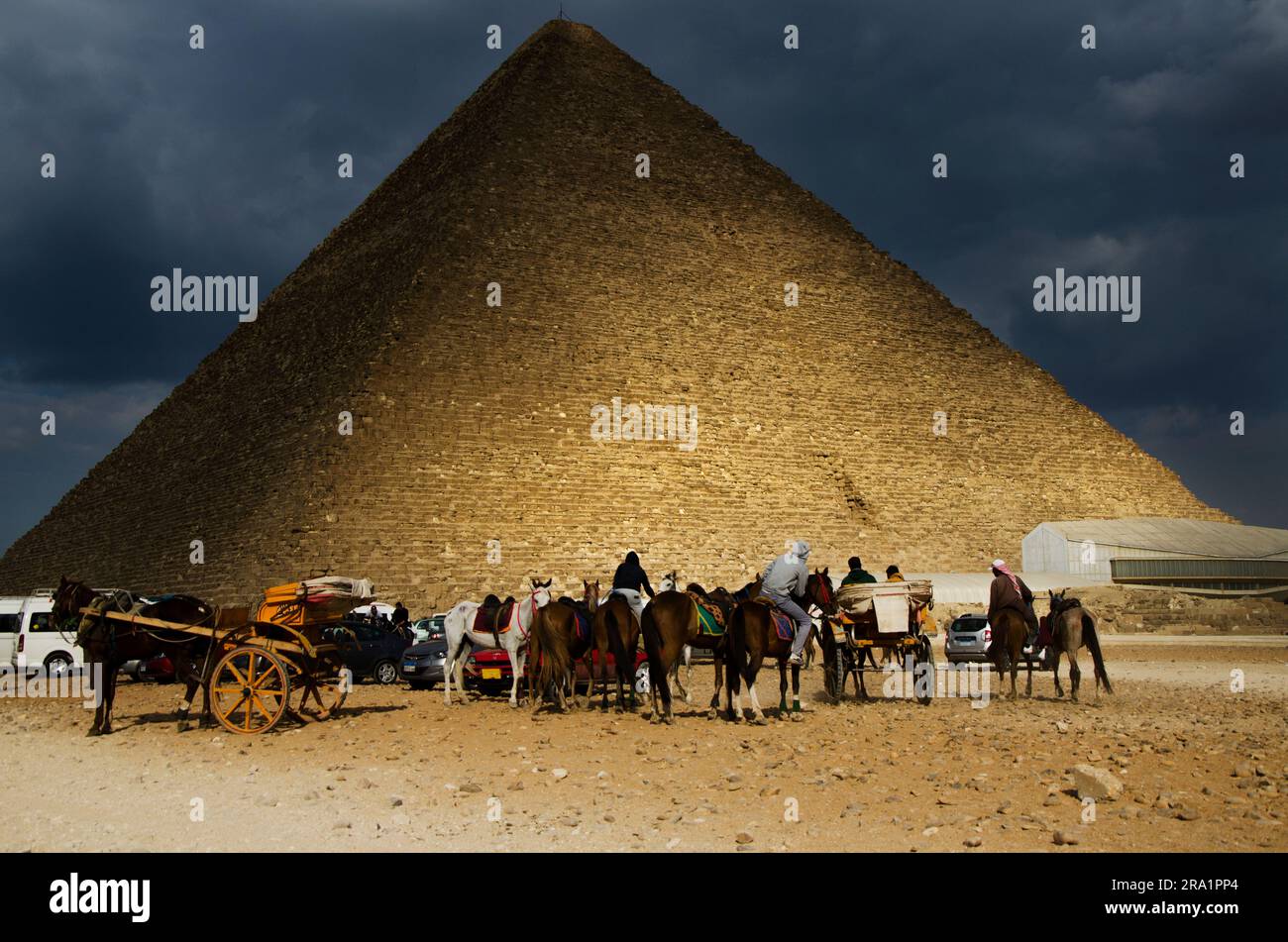 Group of men gathered at the base of a pyramid in Cairo, Egypt Stock ...