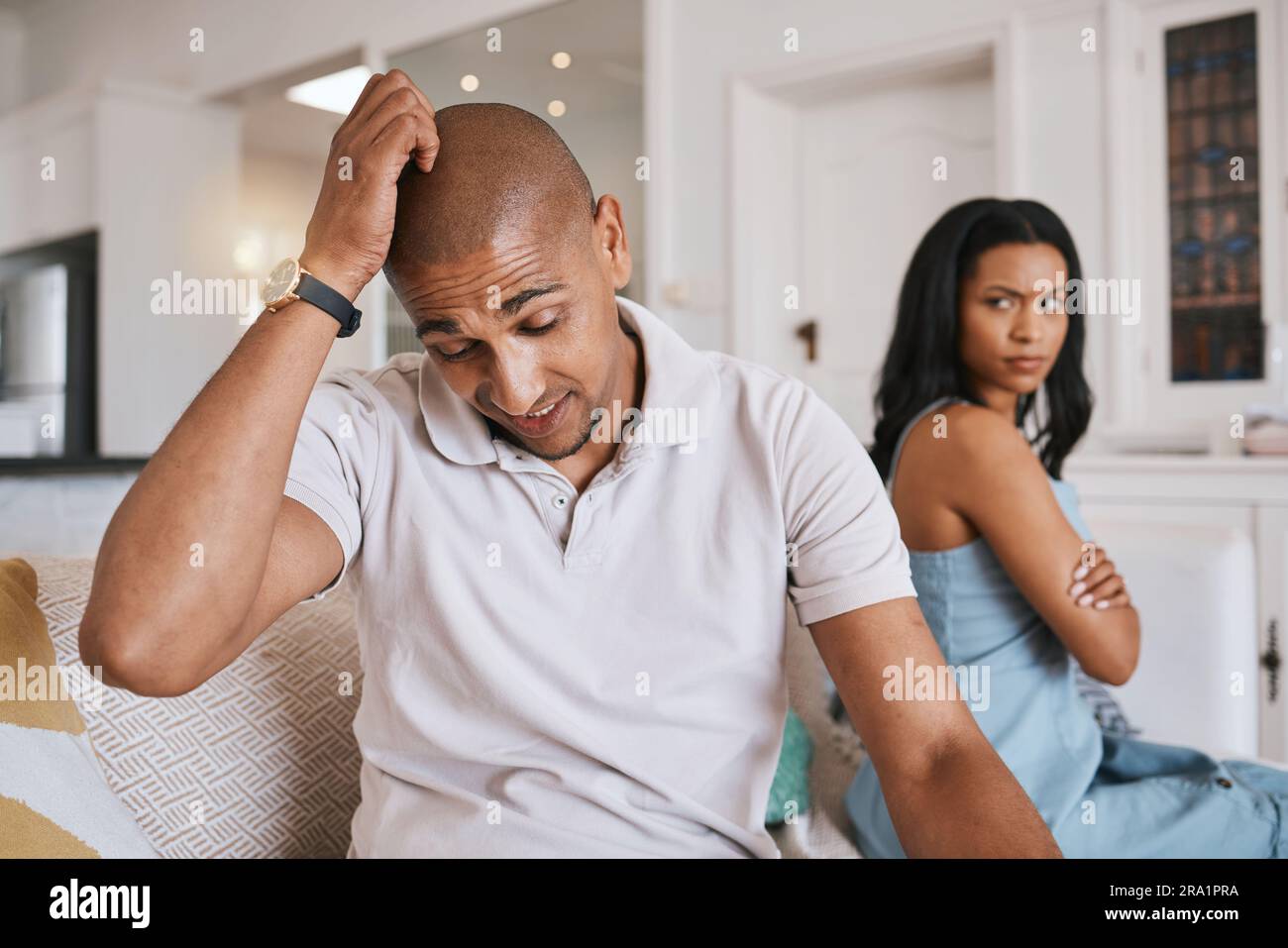 Couple, fight and stress on living room sofa for worry, mistake or ...