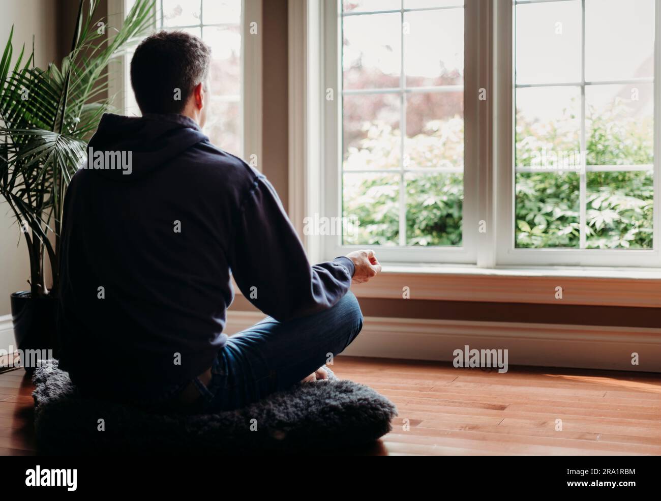 Man sitting in lotus pose hi-res stock photography and images - Alamy