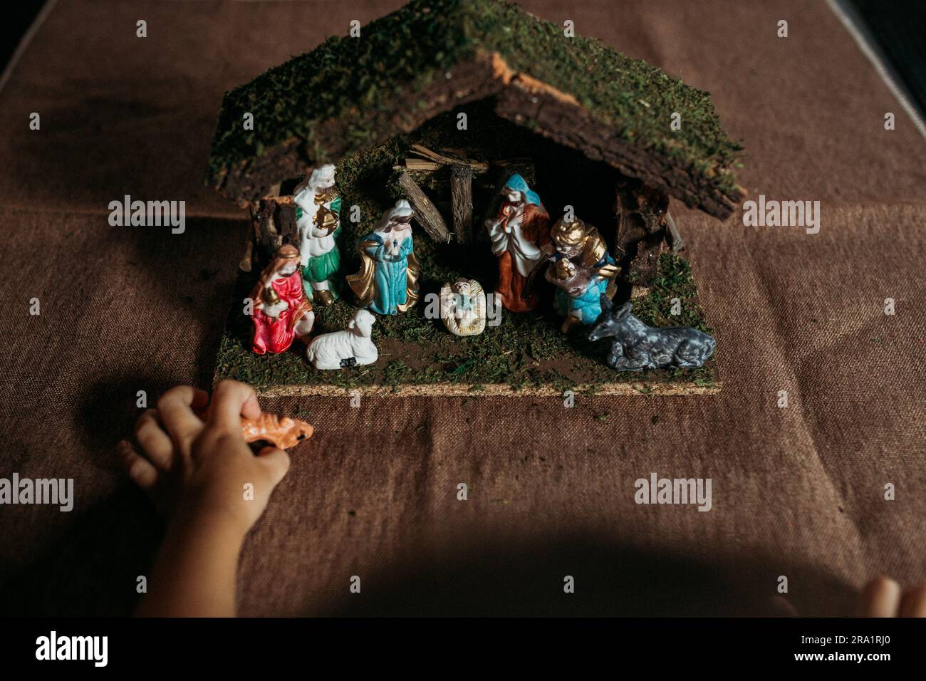 Boy playing with a Nativity scene Stock Photo - Alamy