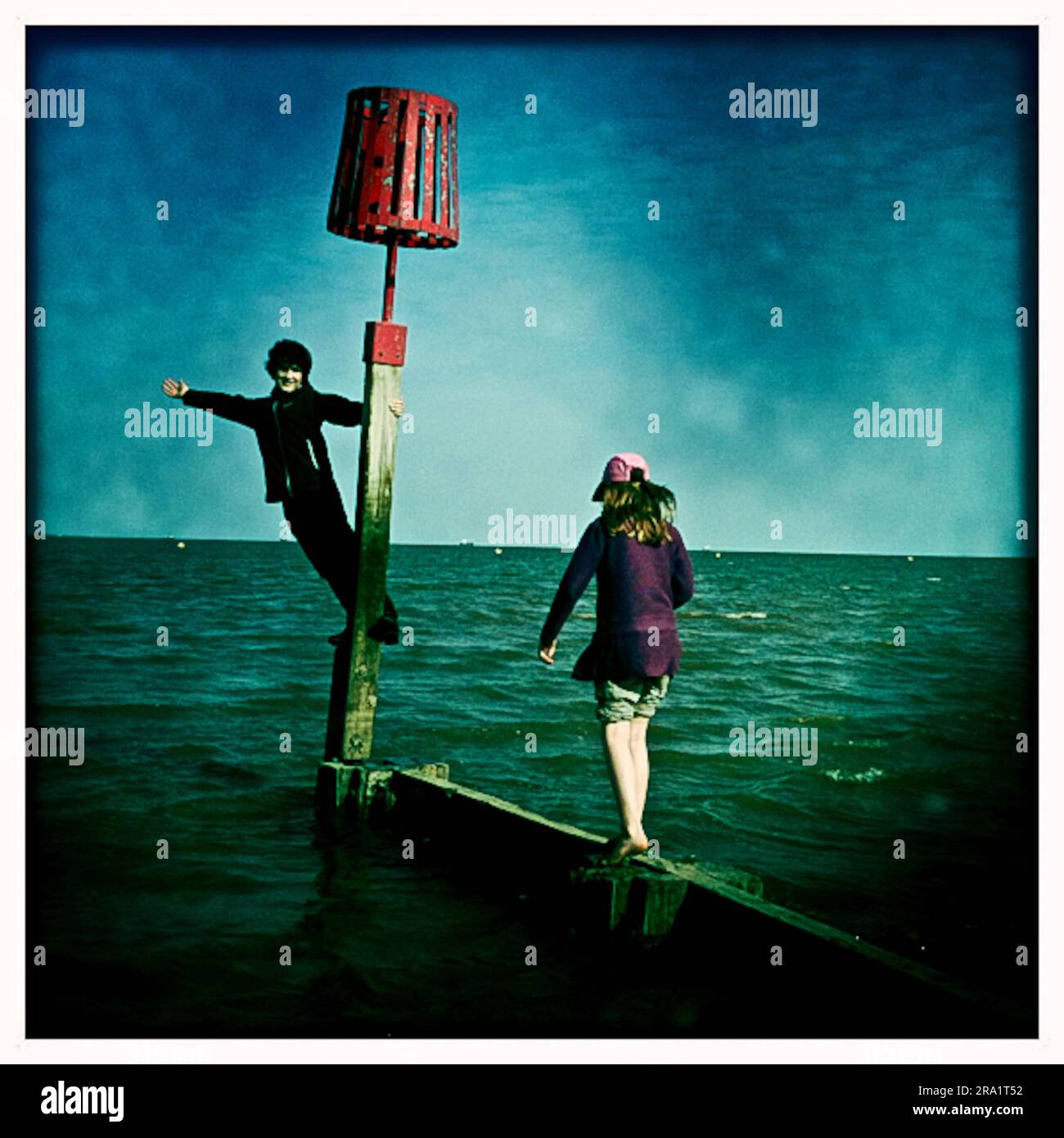 Boy on a jetty Cut Out Stock Images & Pictures - Alamy