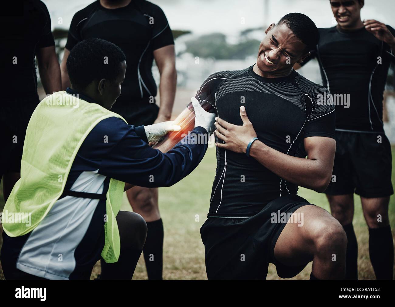 Rugby player, muscle injury and field with pain, team doctor and broken ...