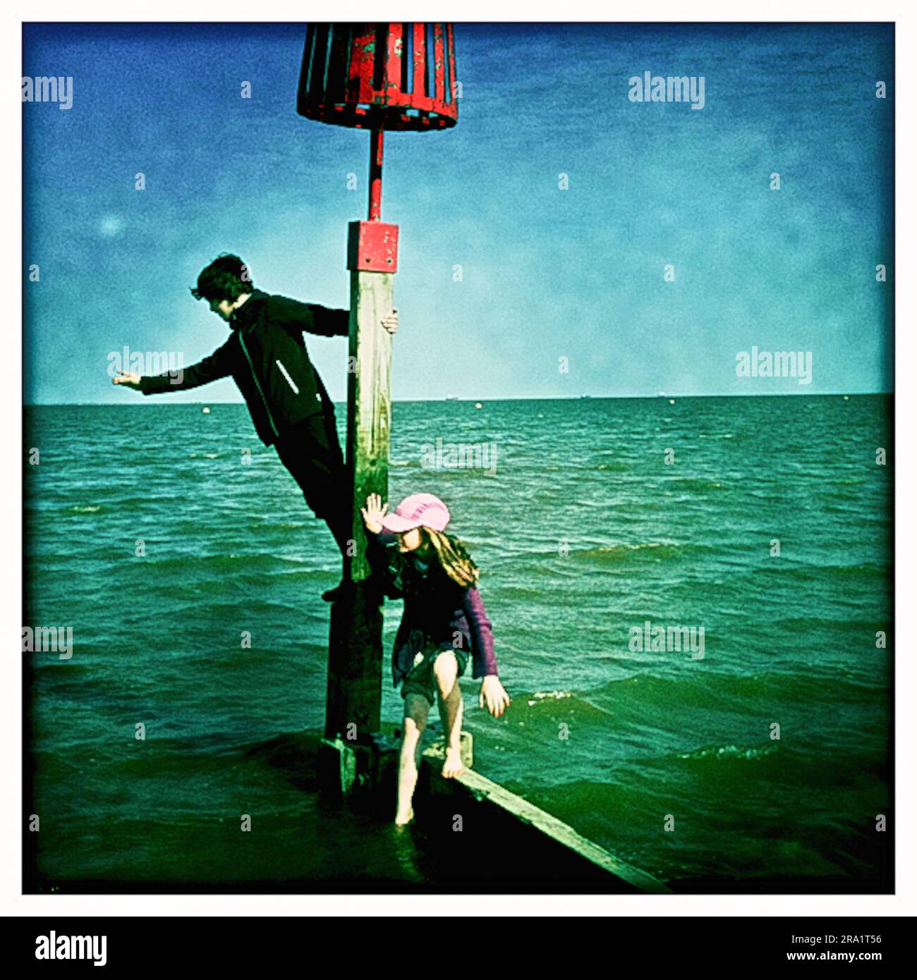 Boy on a jetty Cut Out Stock Images & Pictures - Alamy