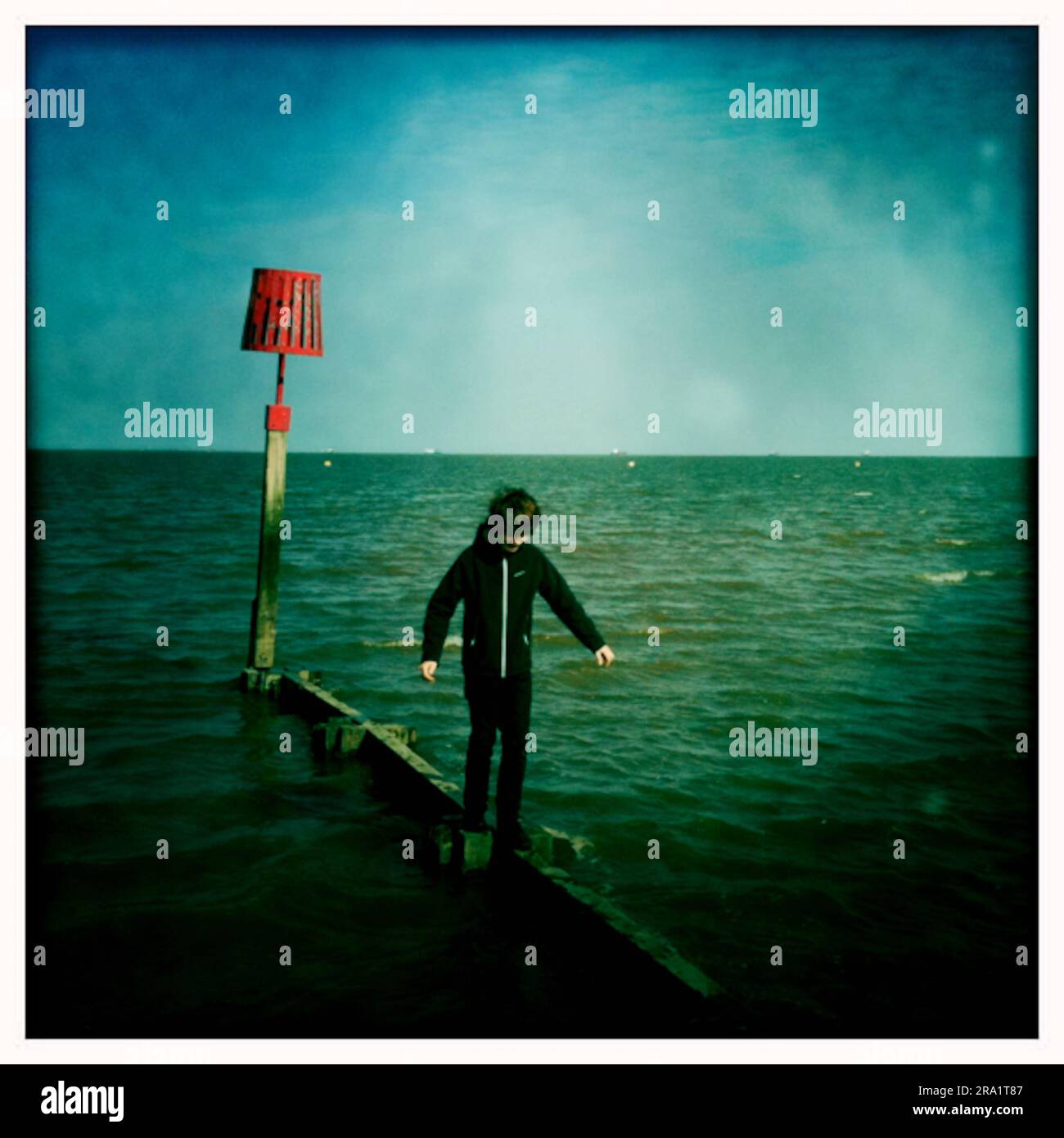 Boy on a jetty Cut Out Stock Images & Pictures - Alamy