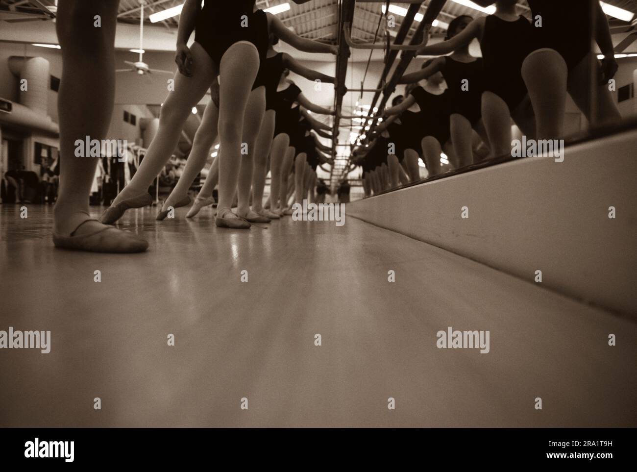 students lining up at the bar for ballet exercises at private school in ...