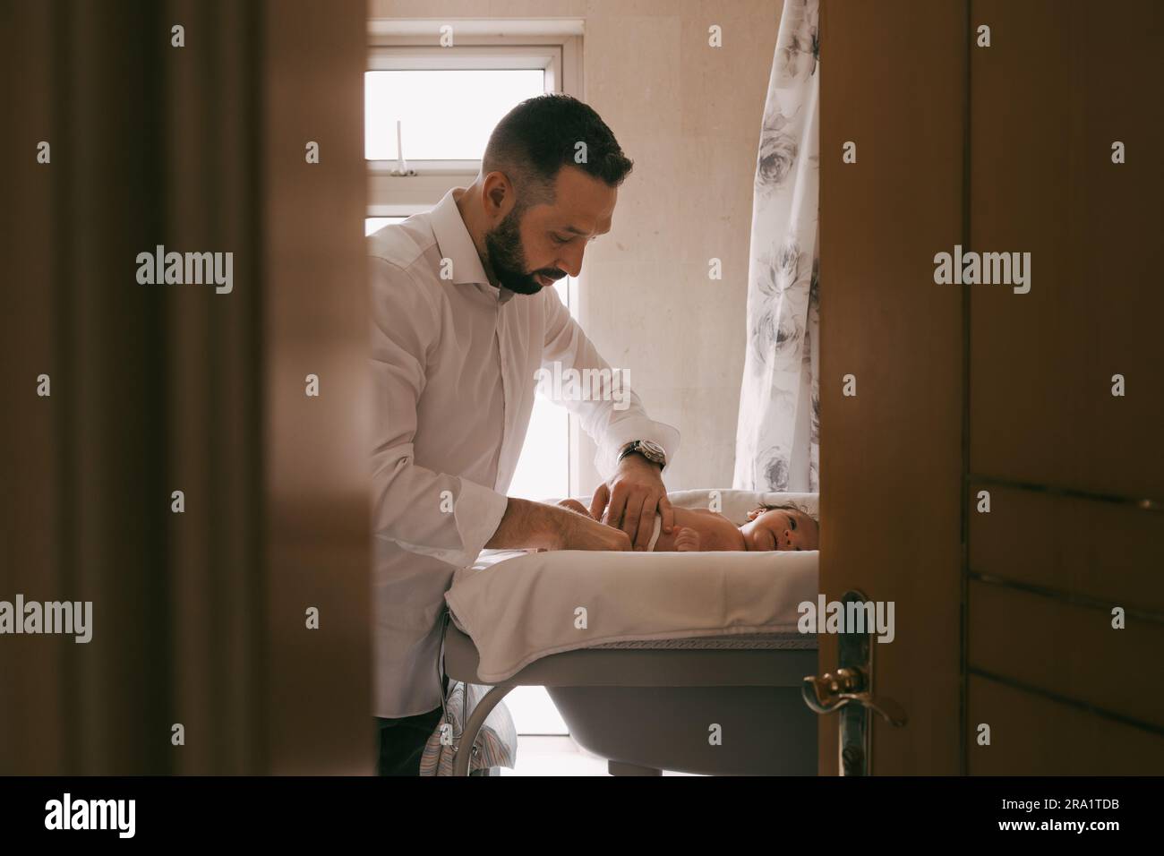 Dad changing baby diaper in the bathroom Stock Photo - Alamy