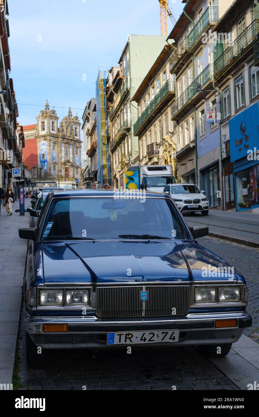 A classic car in front of the tiled Igreja de Santo Ildefonso church in ...