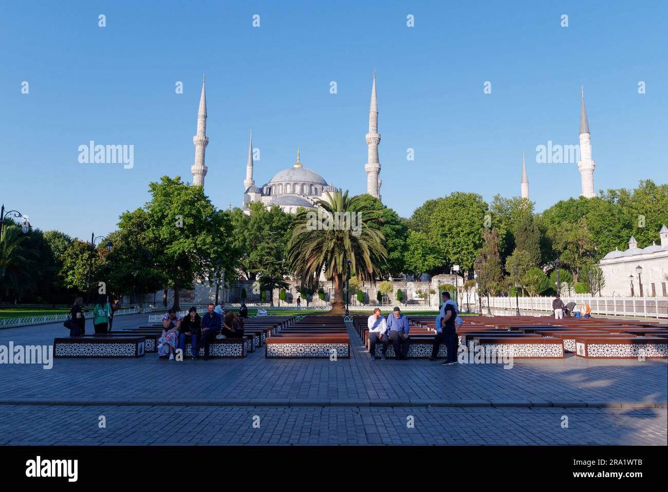 Tourists sitting on benches in the gardens in front of Sulatn Ahmed ...