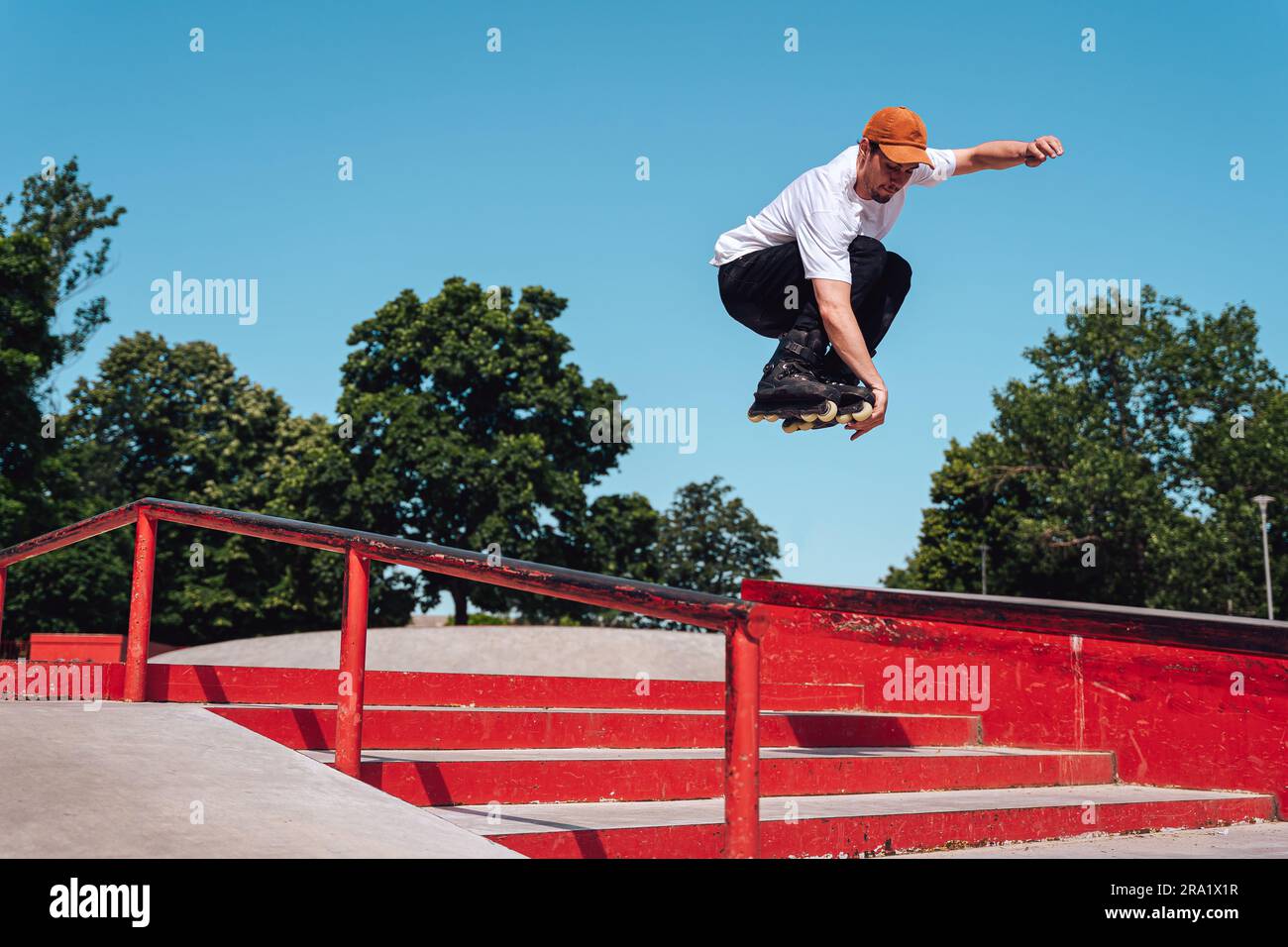 aggressive roller skater performing a trick in skatepark Stock Photo ...