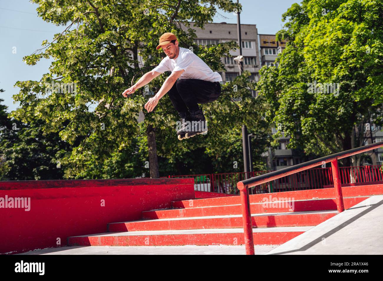 aggressive roller skater performing a trick in skatepark Stock Photo ...