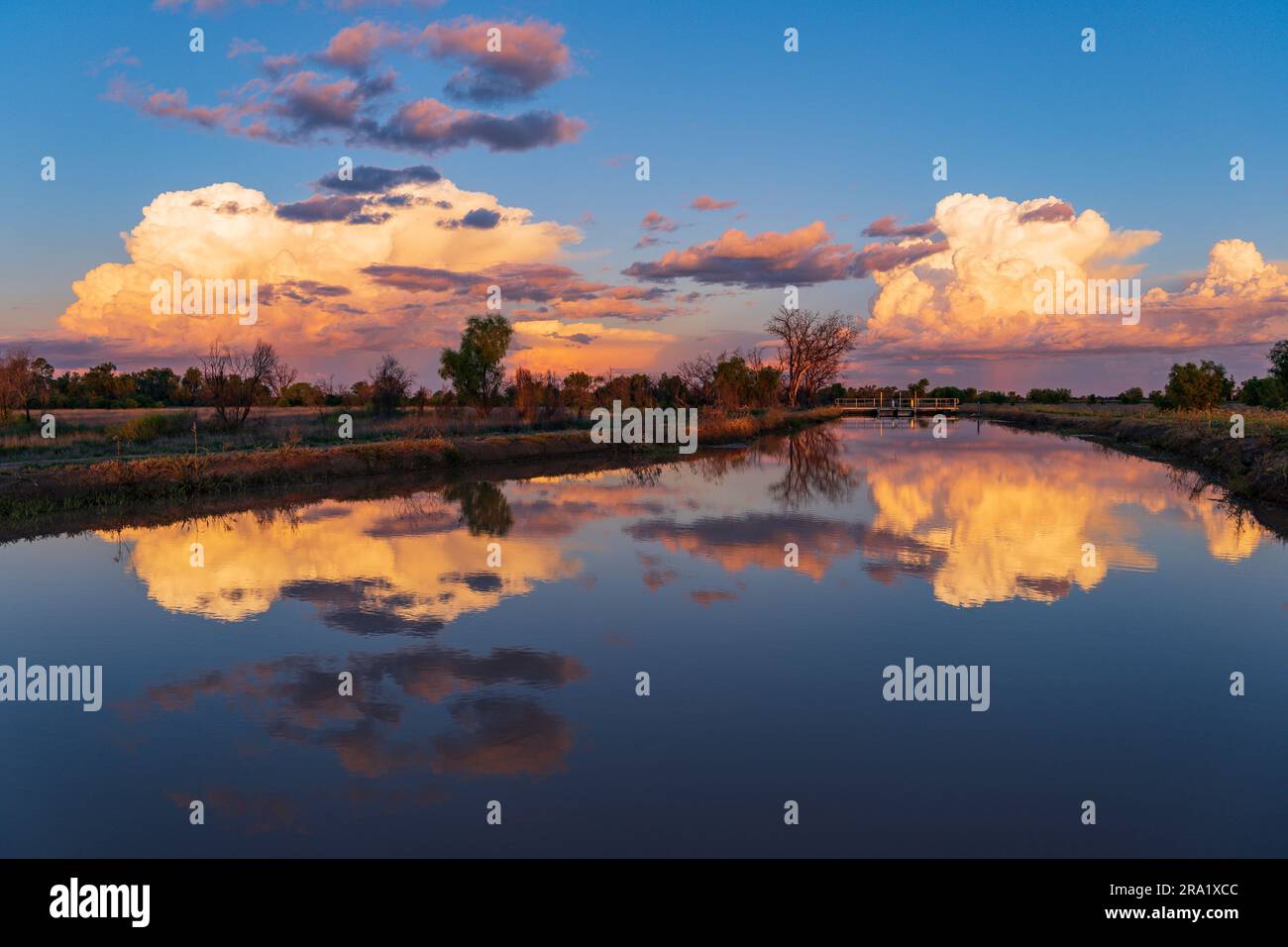 Aerial view of colourful thunderstorm clouds reflected in the calm ...