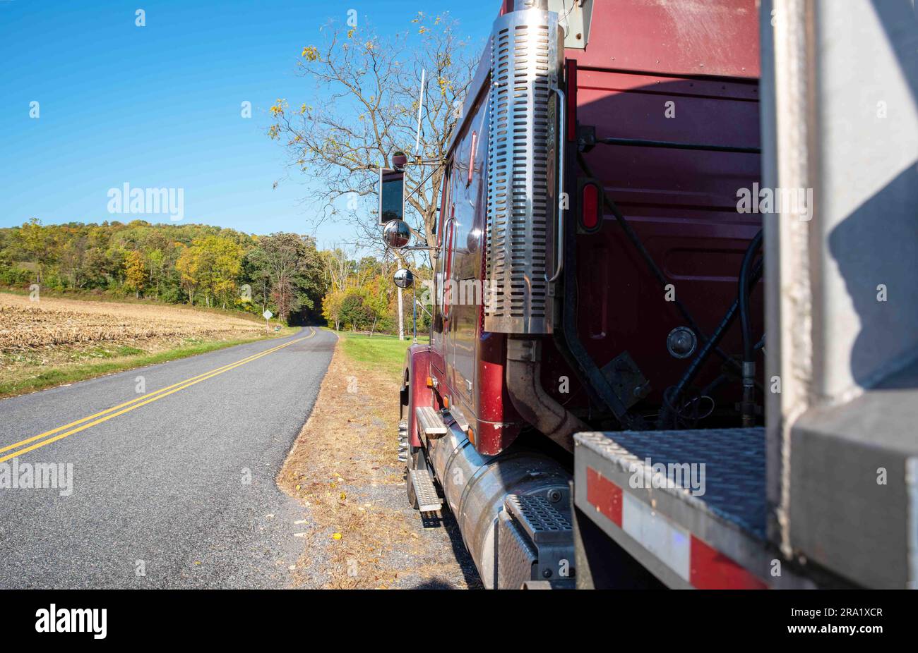 Long side view of large farm truck parked alongside a rural country ...