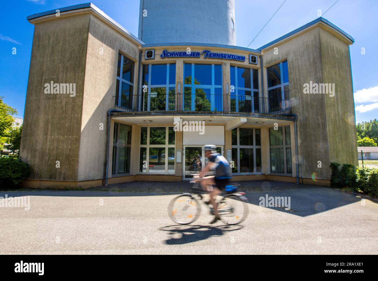 Schwerin, Germany. 30th May, 2023. A cyclist rides past the entrance ...
