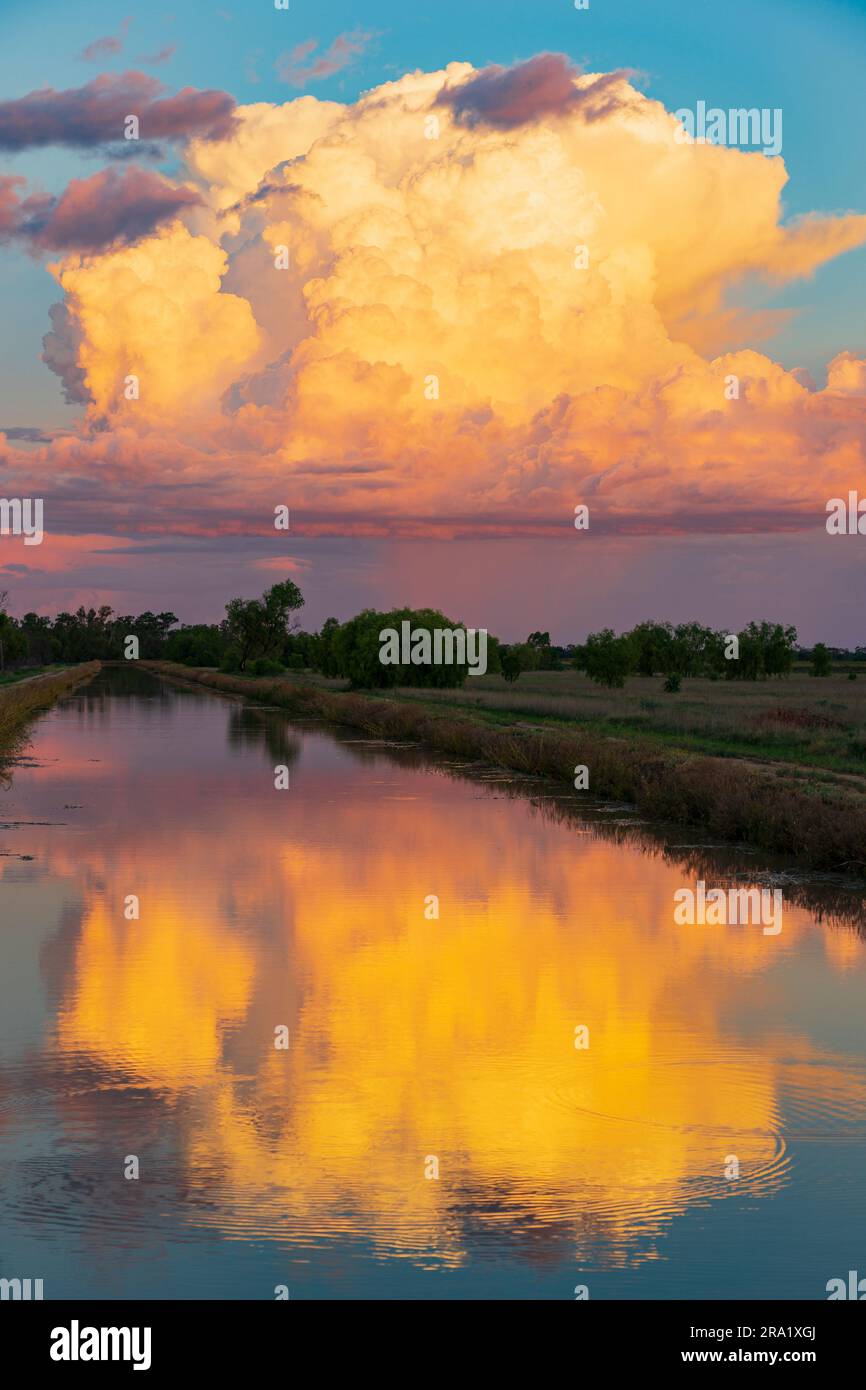 Aerial view of colourful thunderstorm clouds reflected in the calm ...