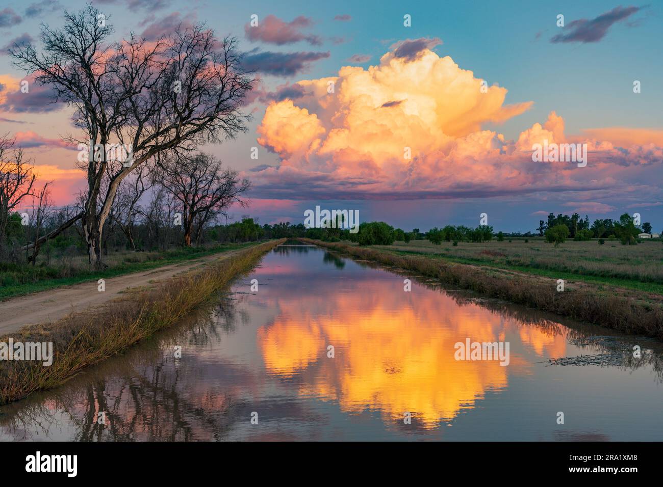 Aerial view of colourful thunderstorm clouds reflected in the calm ...