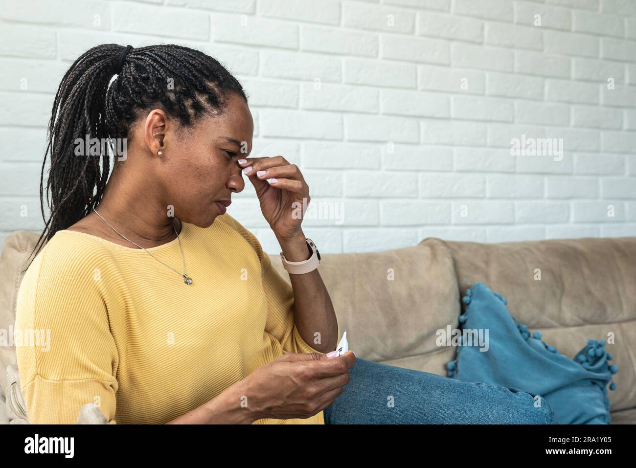 Sick woman checking the result of the thermometer. Business African ...