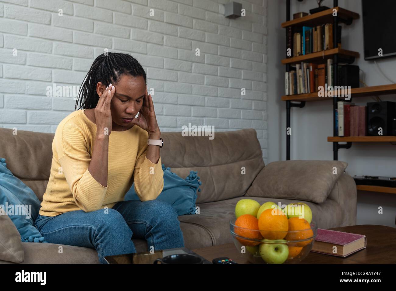 Unhappy depressed young woman touching her head feeling despair. Side ...