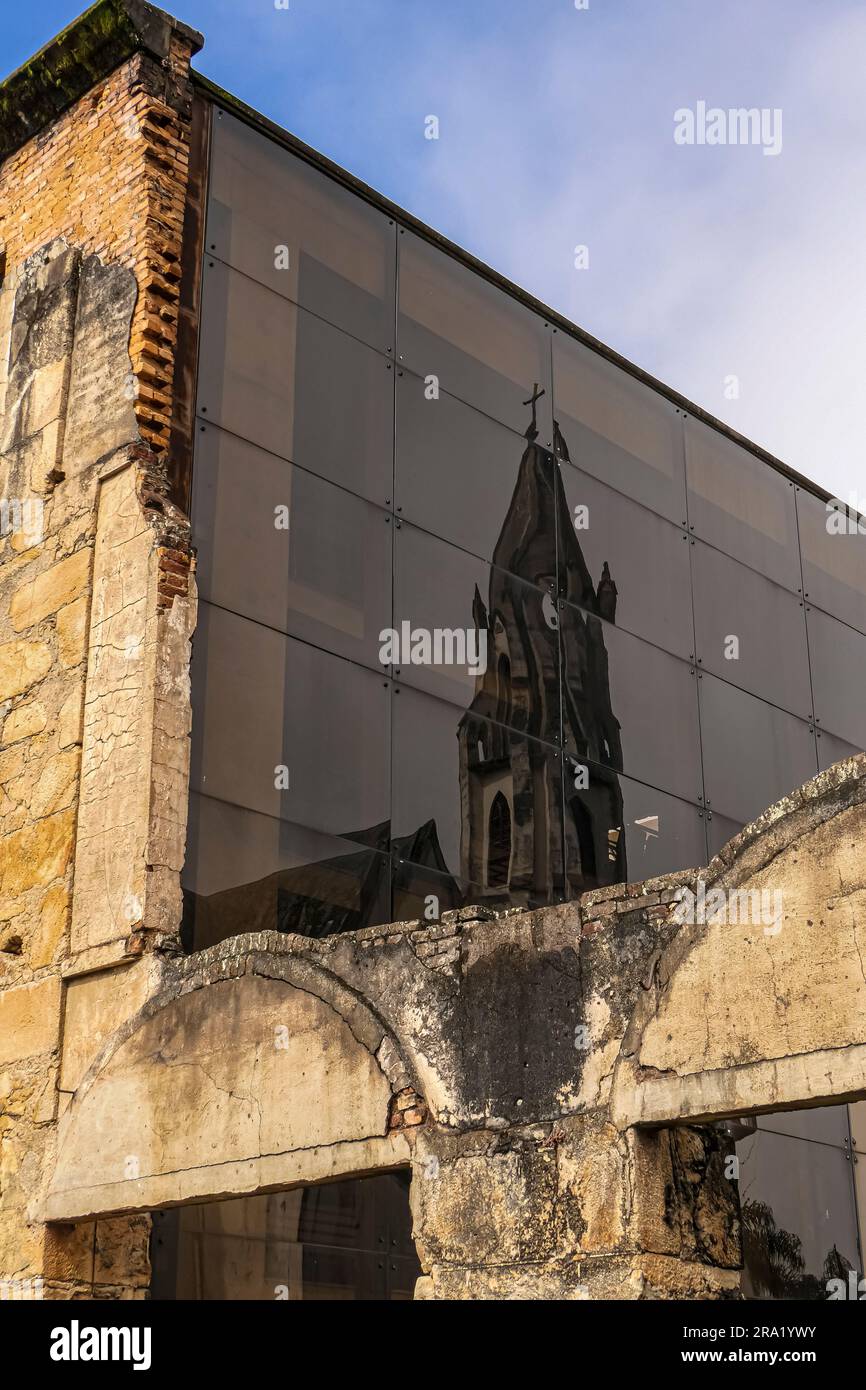 Mirror reflection of church in glass facade of the restored museum ...
