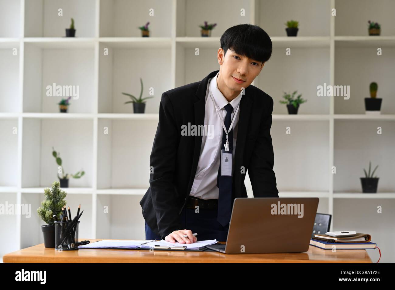Handsome male manager wearing formal clothes standing and smiling ...